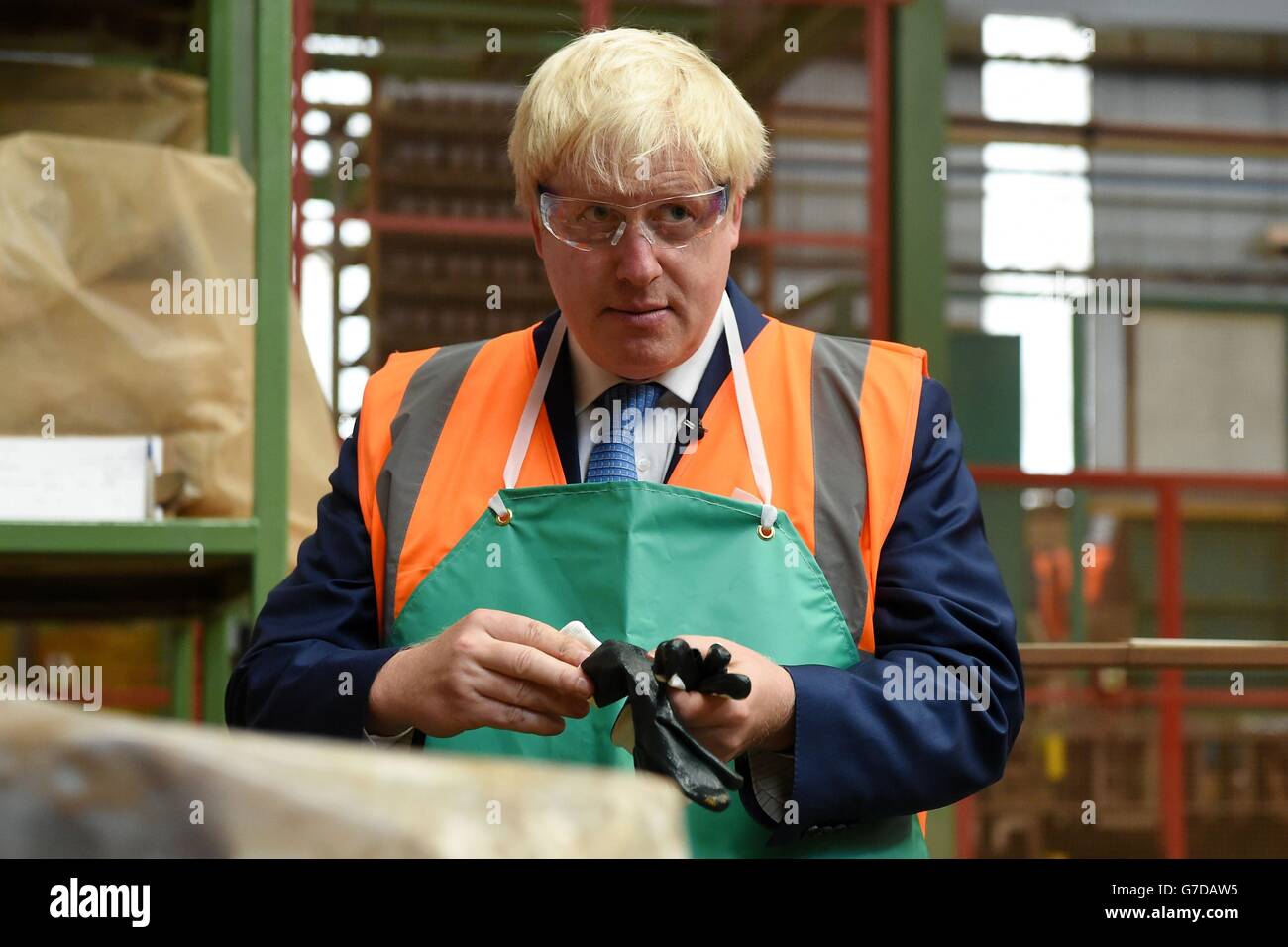 Mayor of London Boris Johnson makes his own brick during a visit to ...