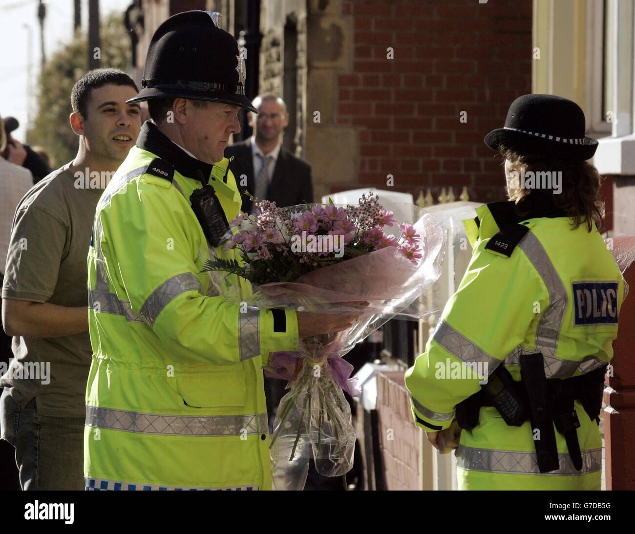 Crime terrorism hostage family house exterior police flowers bouquet hi ...