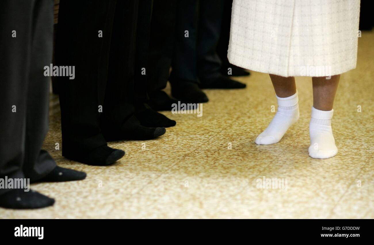 Britain's Queen Elizabeth II stands in a pair of socks during a visit ...