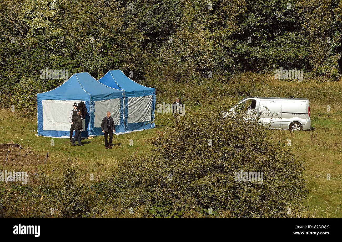 A private ambulance arrives to remove a body from a police tent ...