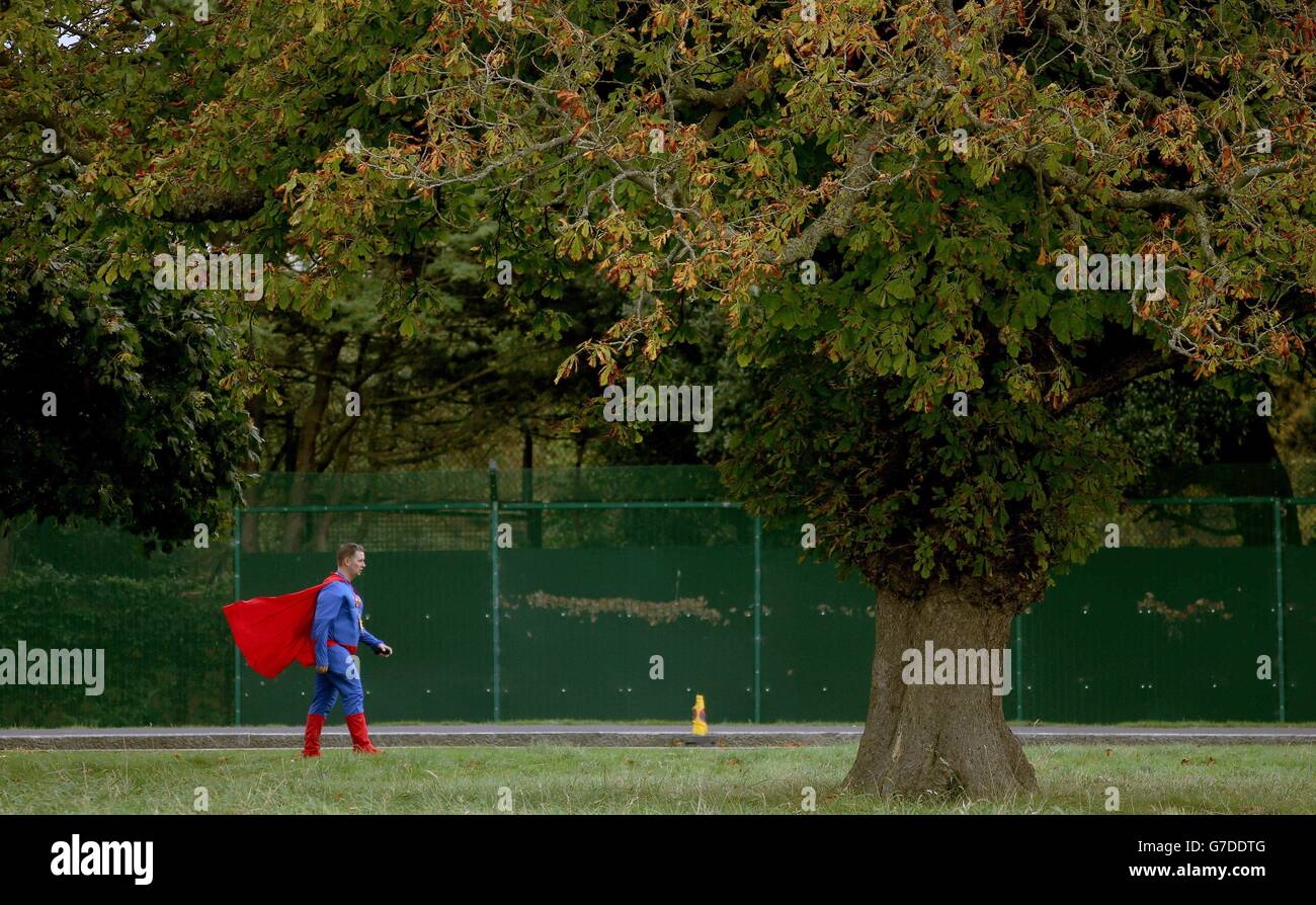 STANDALONE Photo. A man dressed as Superman makes his way home after ...