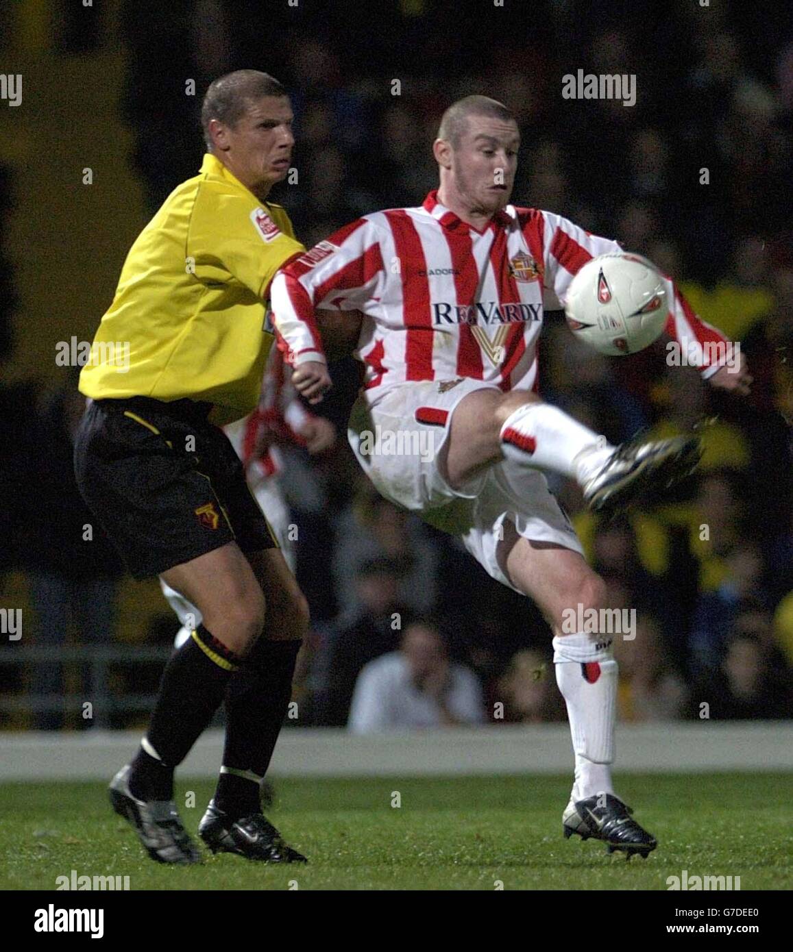 Sunderland's Stephen Elliott (right) is challenged byWatford's Neil Cox ...