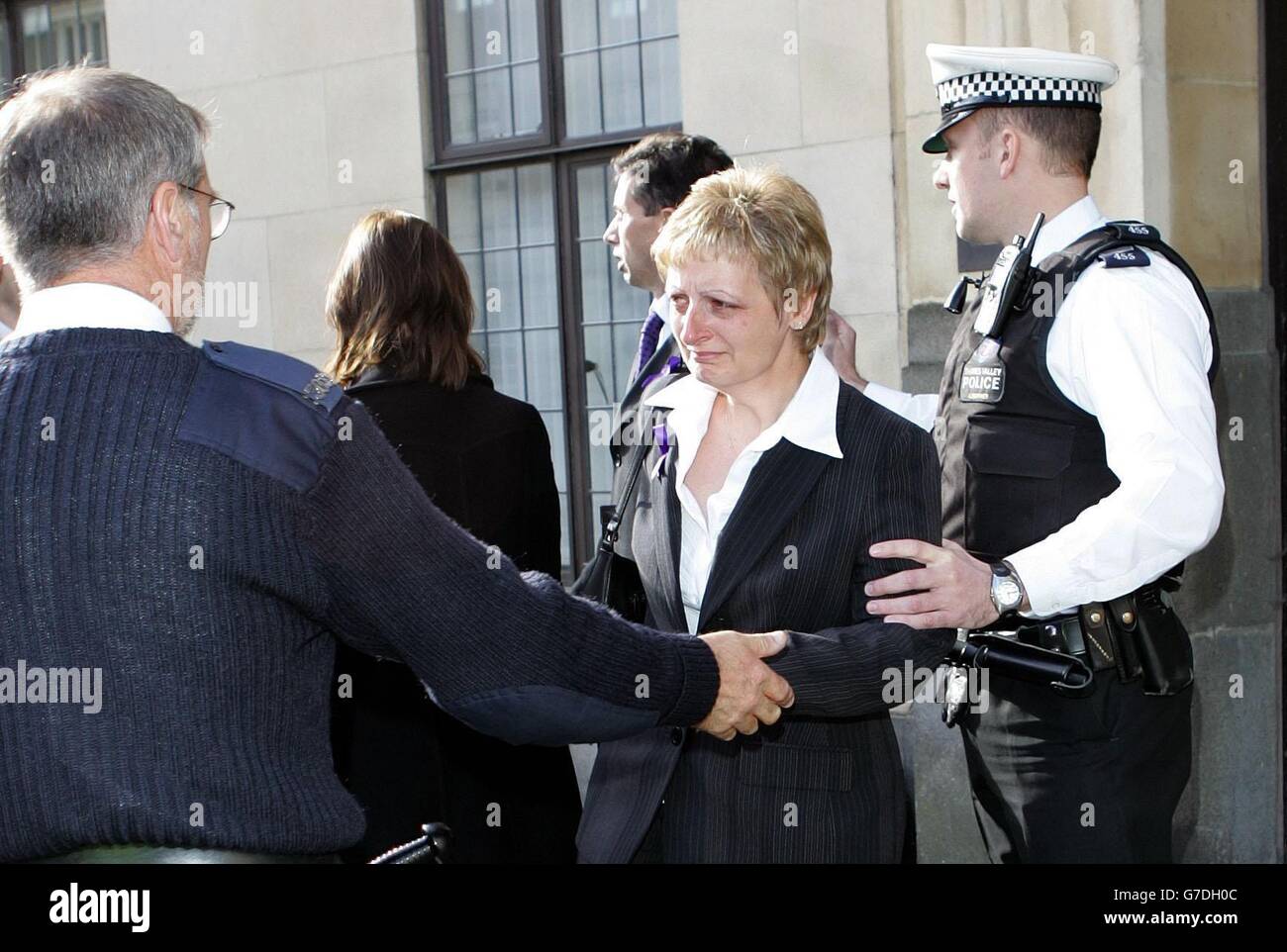 A tearful Mrs Susan Jones is led away by police from Oxford Crown Court ...