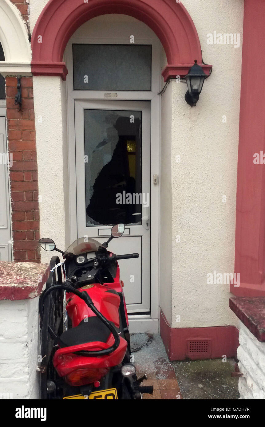 A smashed door at a house in Portsmouth, Hampshire, after six people ...
