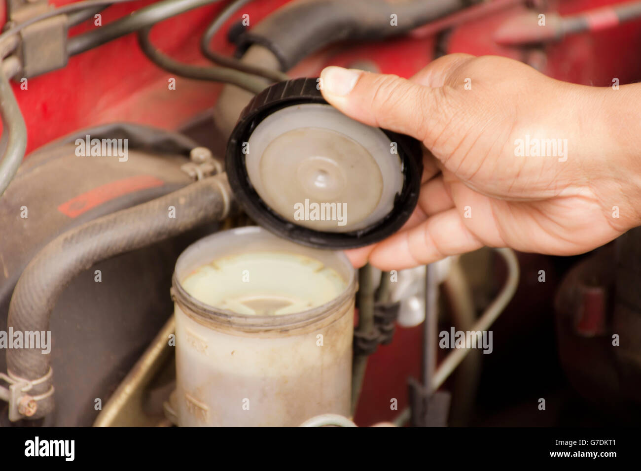 Check brake fluid inlet and Car maintenance with tap in his hand ...