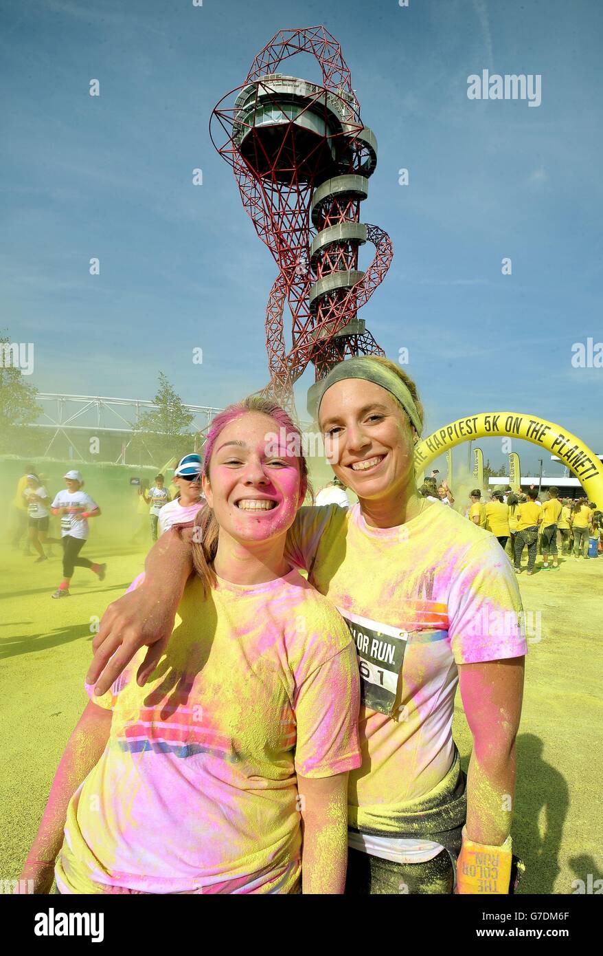 Competitors take part in the Dulux Color Run, runners are covered with ...