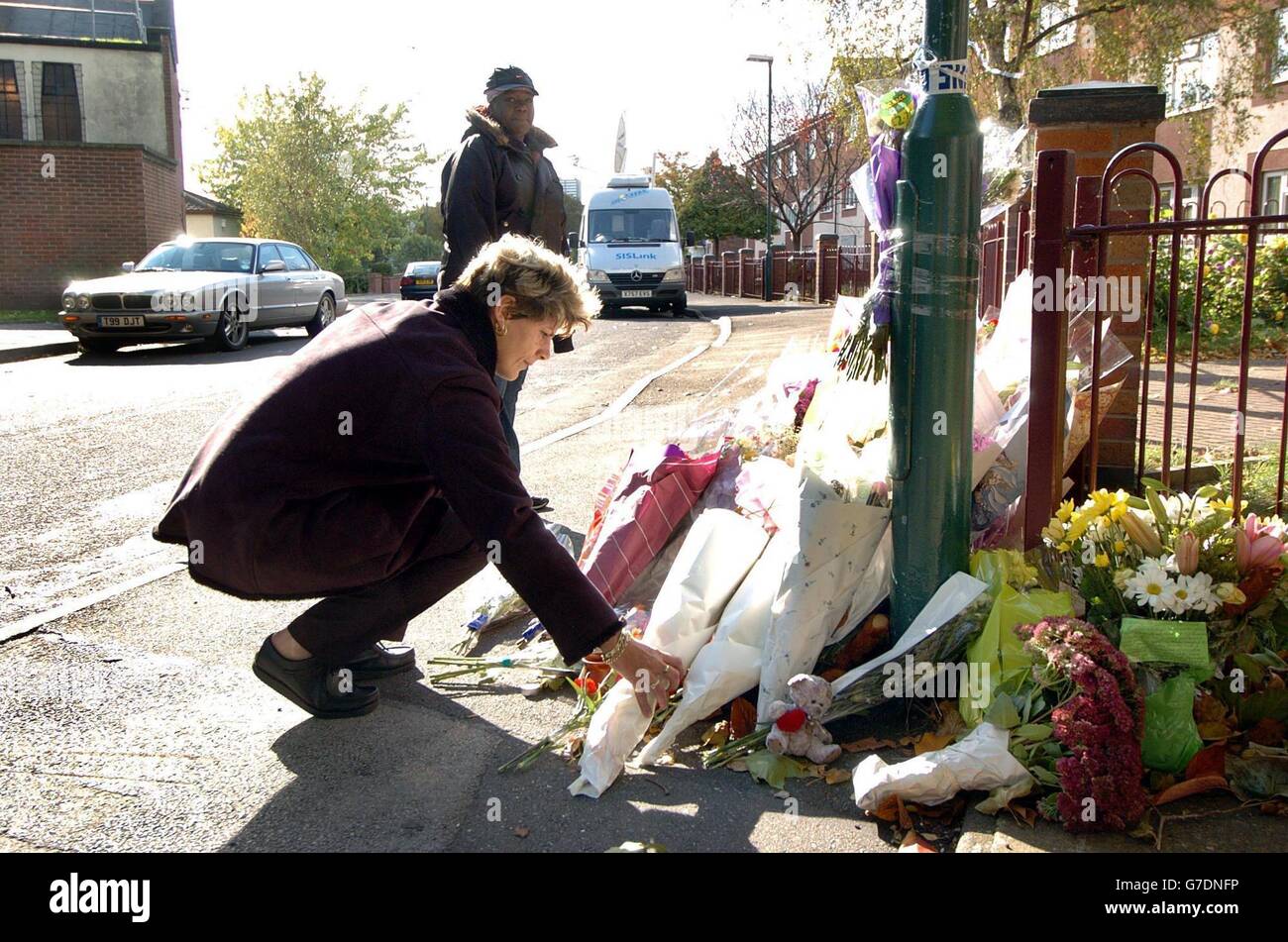 A well-wisher leaves a floral tribute at the scene where 14-year-old ...