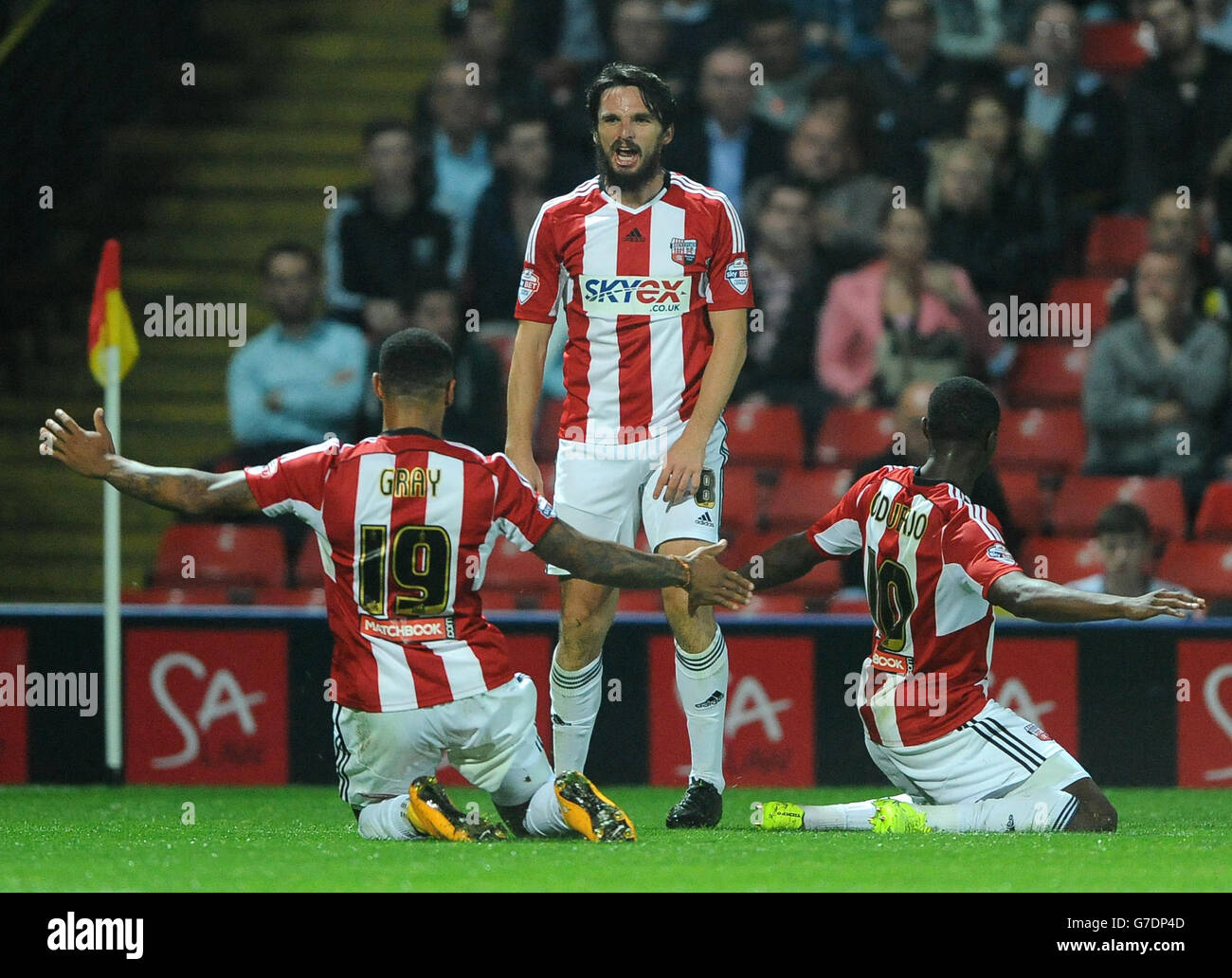 Brentford's Jonathan Douglas (centre) celebrates with Andre Gray (left ...