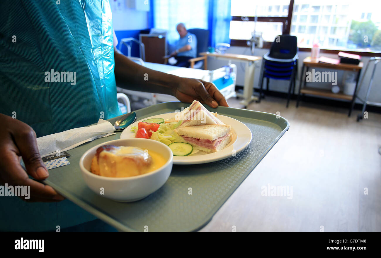 A nurse gives food to patients at the Royal Liverpool University ...