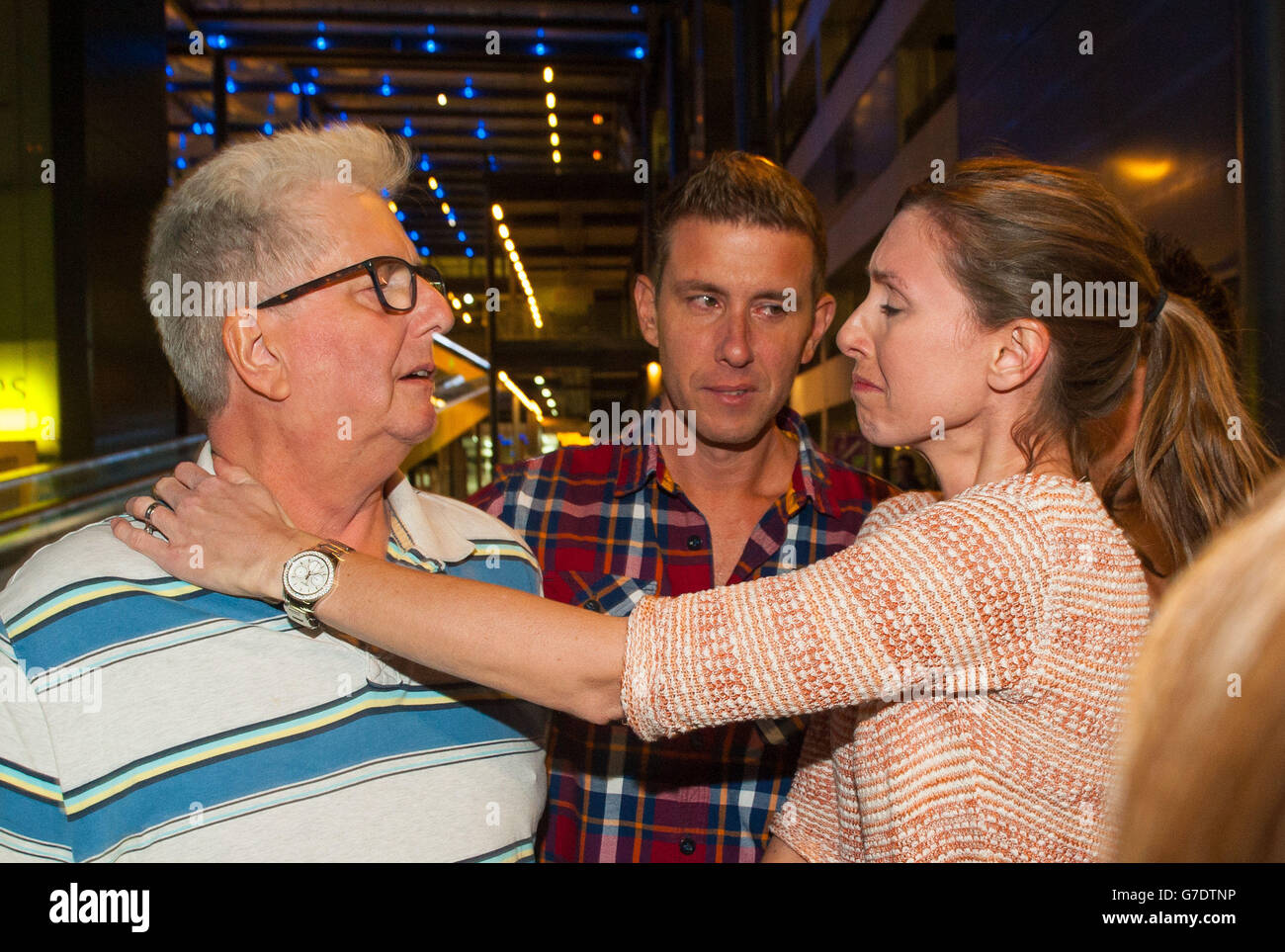 Ray Cole (left) is greeted by his son Adrian and daughter Gemma Scott ...