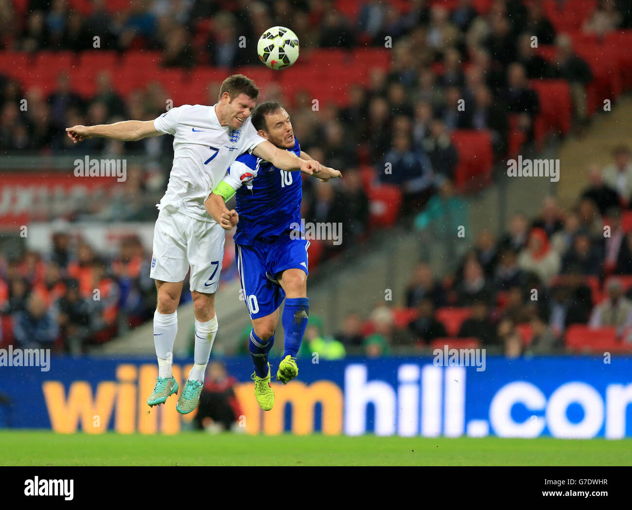 England's James Milner (left) and San Marino's Andy Selva battle for ...