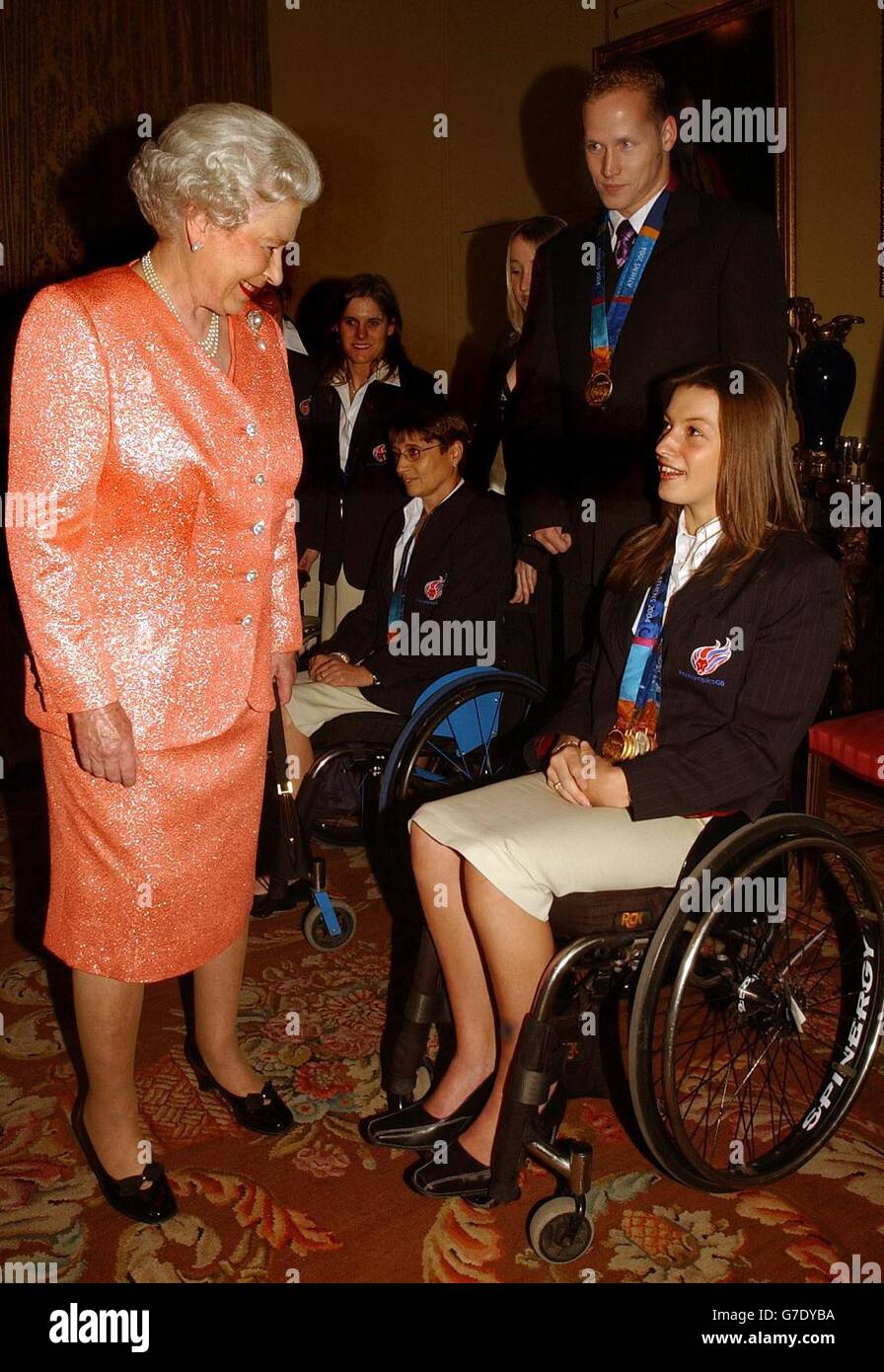 Britain's Queen Elizabeth II (left) talks to Nyree Lewis who won two ...