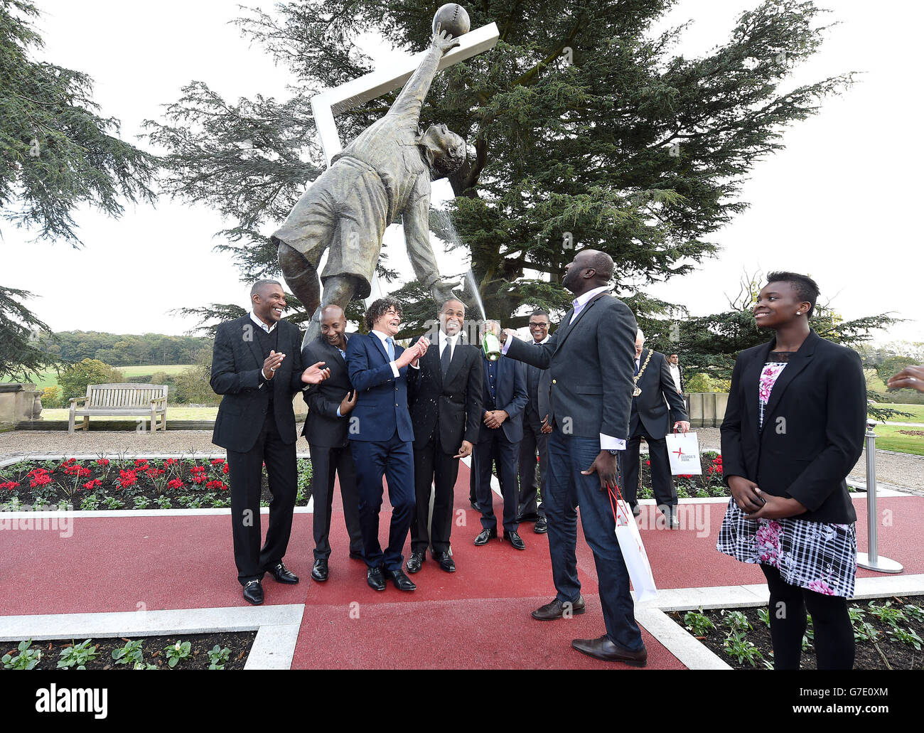Mo Samba (right) sprays champagne over (left to right) Dave Regis ...