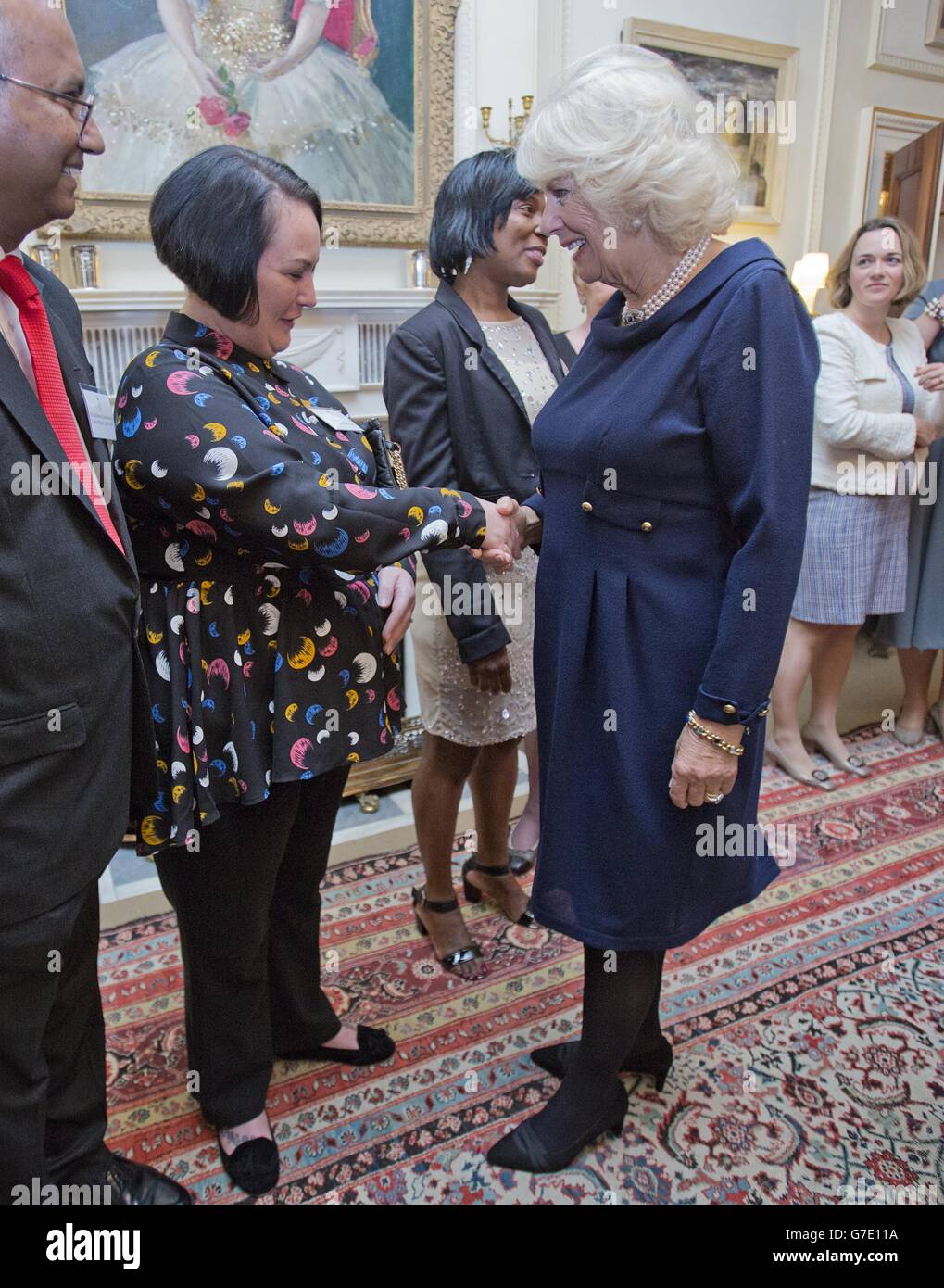 The Duchess of Cornwall speaks with Emma Watson, who was helped by her ...