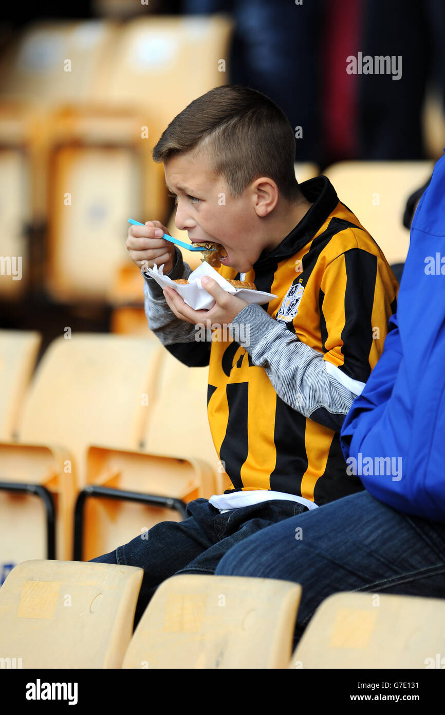 A young Port Vale fan enjoys his pre match meal in the stands at Vale ...