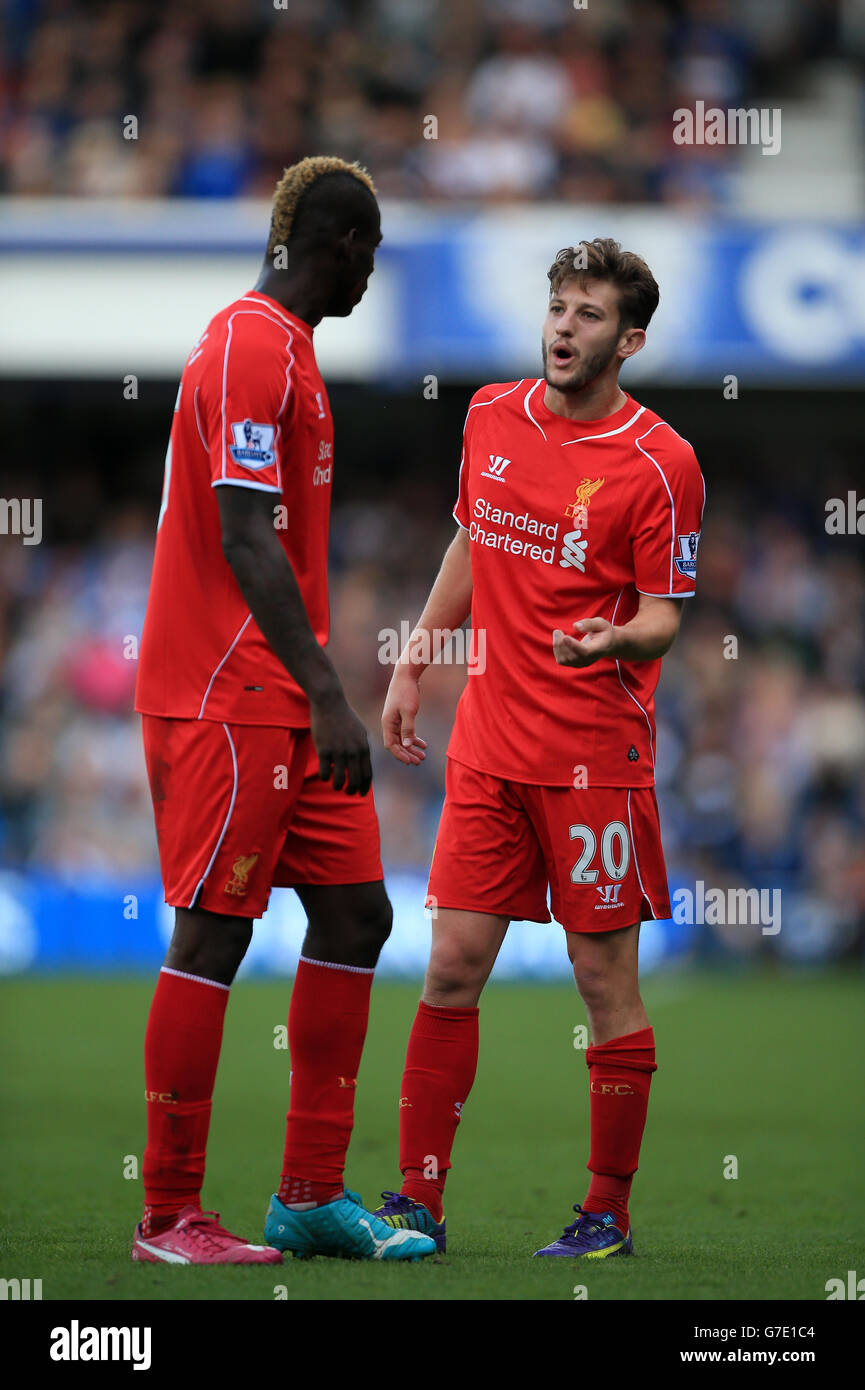 Liverpool's Adam Lallana speaks with Liverpool's Mario Balotelli (left ...