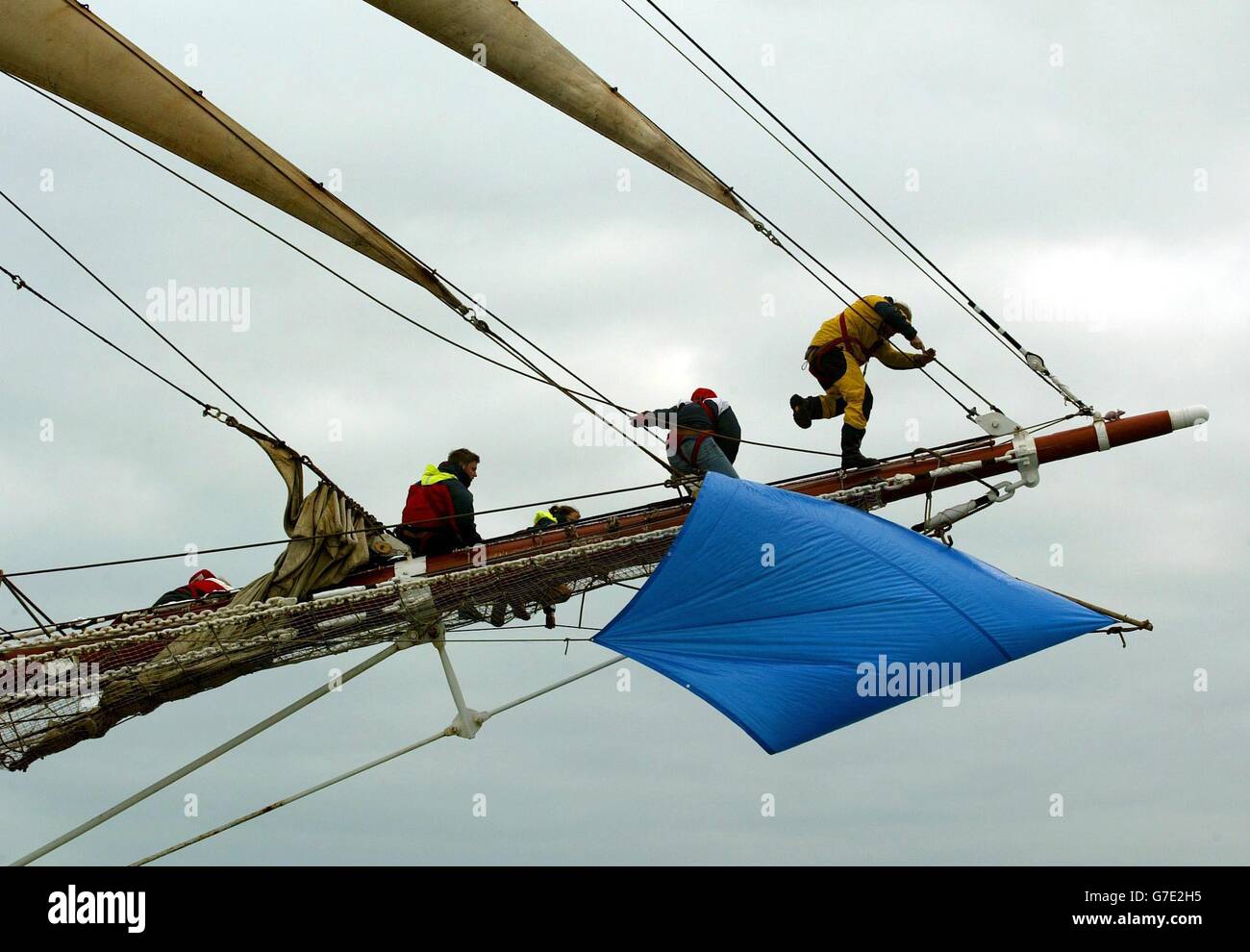 Crew members aboard the tall ship Prince William work on the bowsprit ...