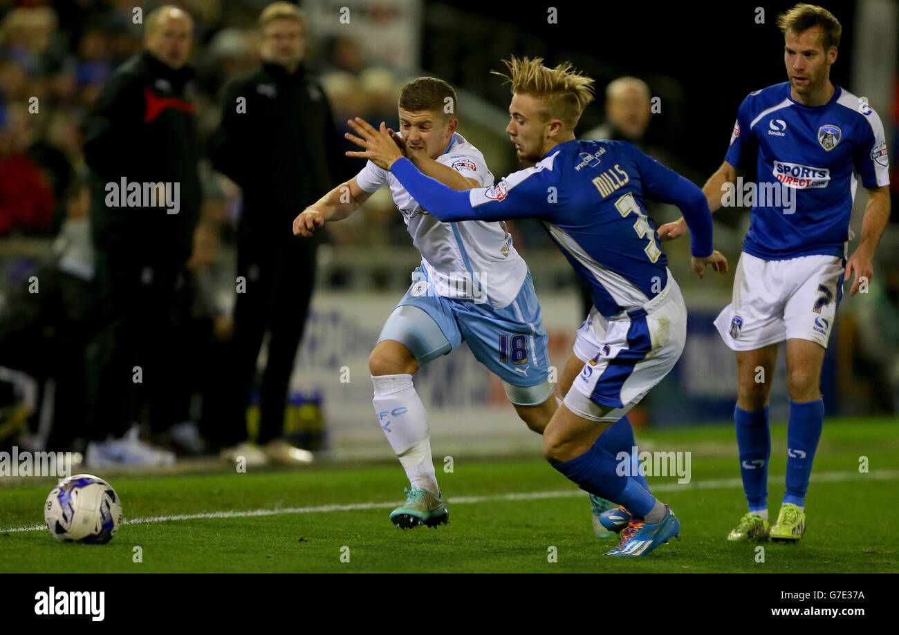 Coventry City's Aaron Phillips (left) takes on Oldham Athletic's Joseph ...