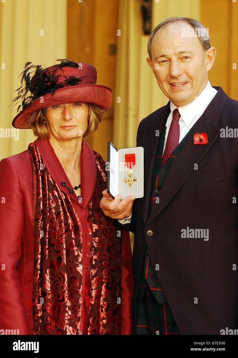 Mr john whitehead with his wife marilyn holds his obe hi-res stock ...
