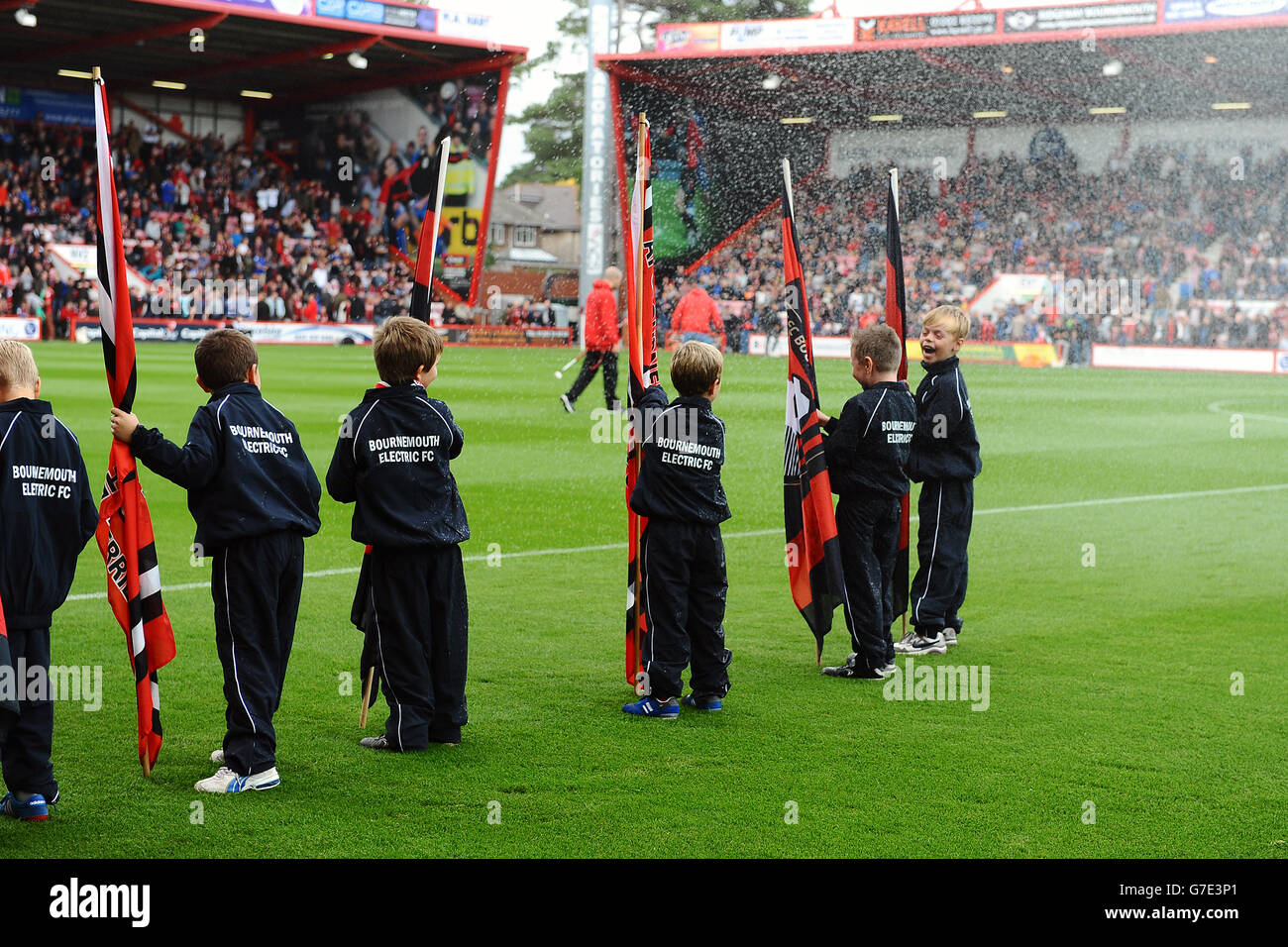 Bournemouth mascots forming the guard of honour get sprayed by the ...