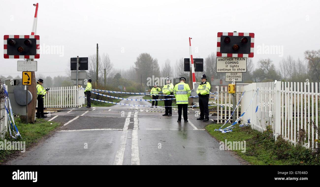 A policeman stand on the level crossing near to the scene of the crash ...