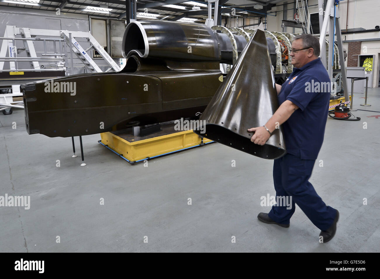 An engineer carries the titanium tipped carbon fibre nose cone inside ...