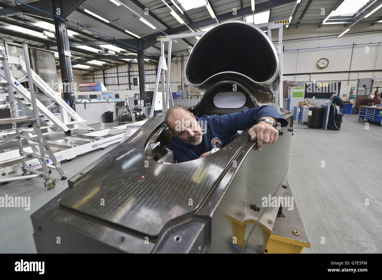 An engineer works on the air intake and carbon fiber cockpit section on ...