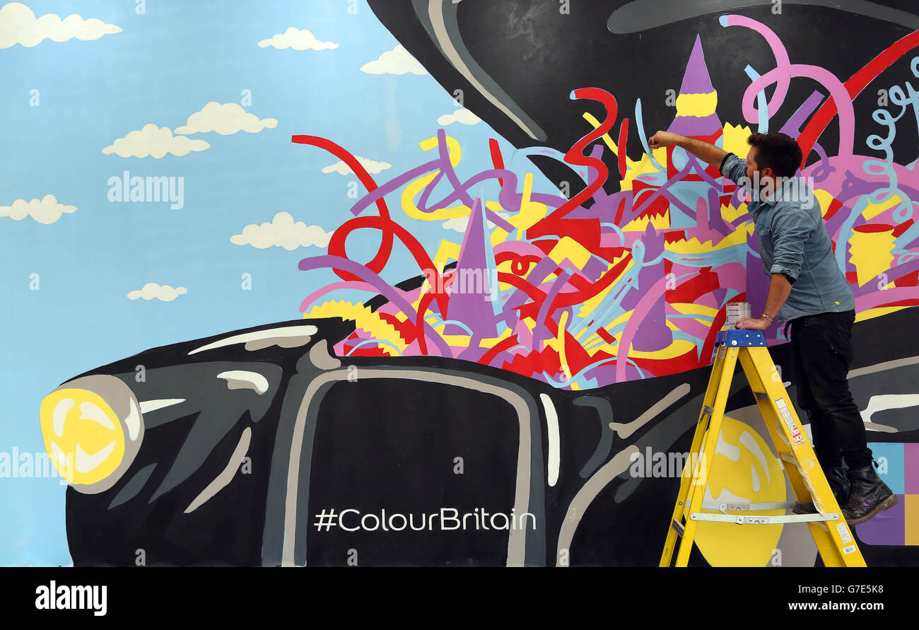 EDITORIAL USE ONLY Muralist Peter Barber puts the finishing touches to ...