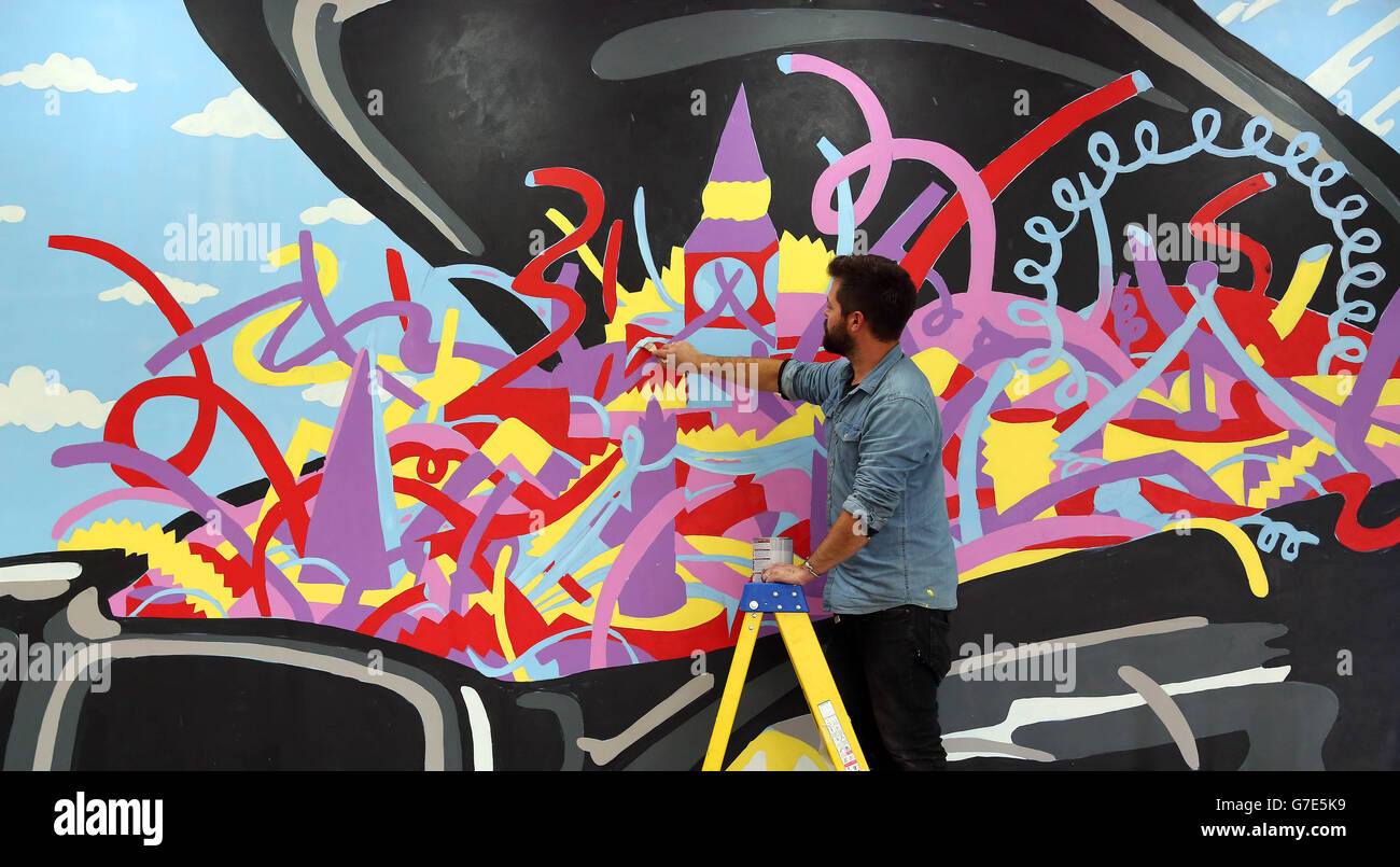 EDITORIAL USE ONLY Muralist Peter Barber puts the finishing touches to ...