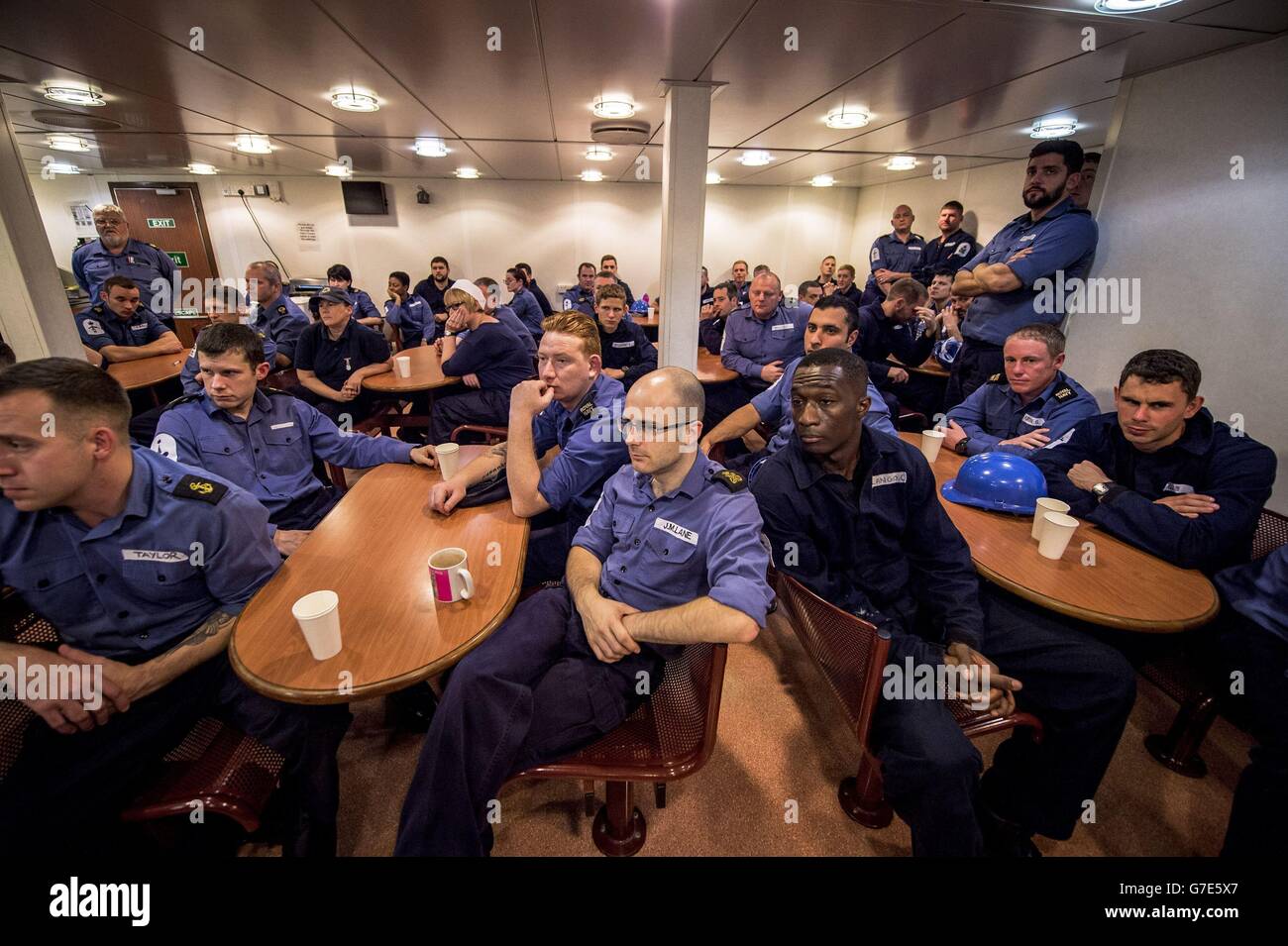 Royal Navy and ship personnel receive a briefing on the hazards of the ...