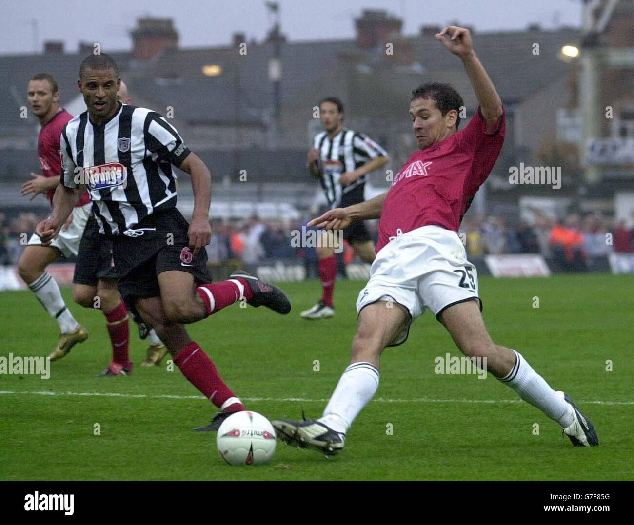 Grimsby's Justin Whittle (left) and Swansea's Scott Fitzgerald in ...