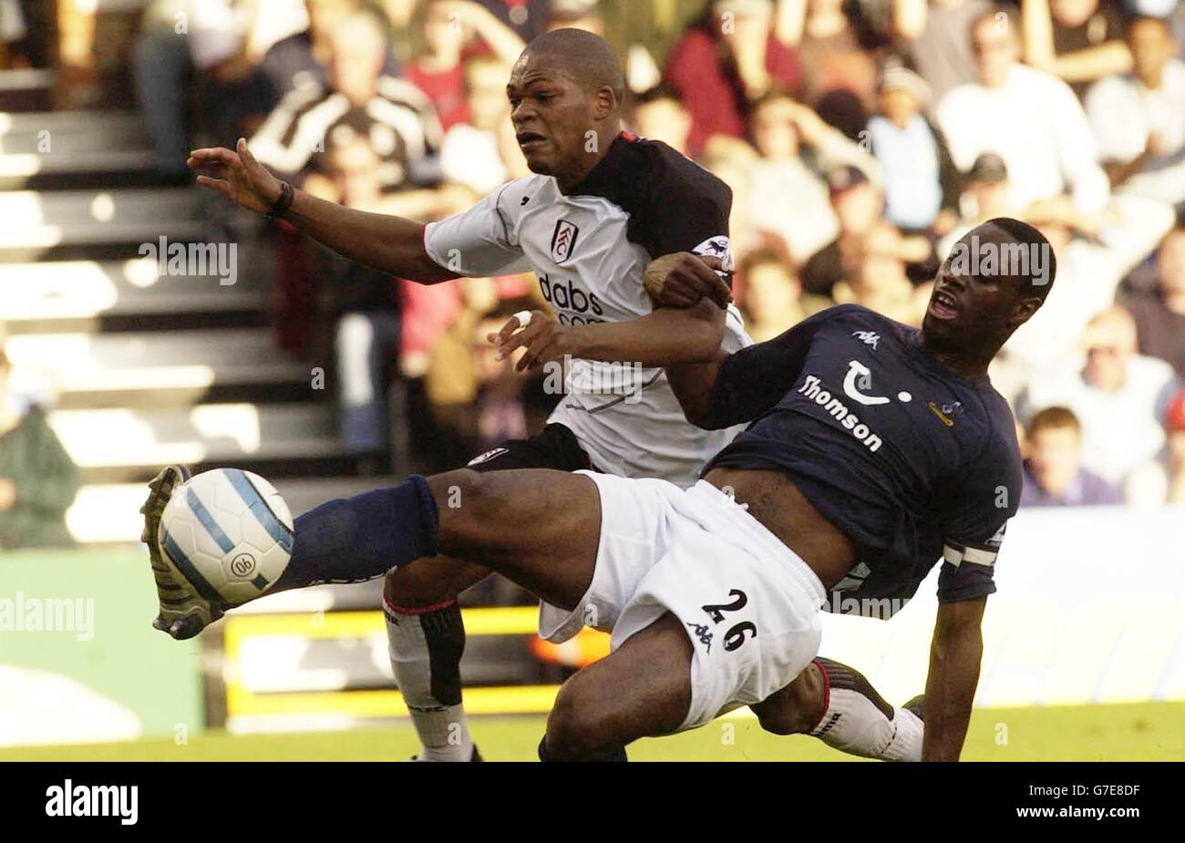Tottenham Hotspur's Ledley King stretches to stop Fulham's Collins John ...