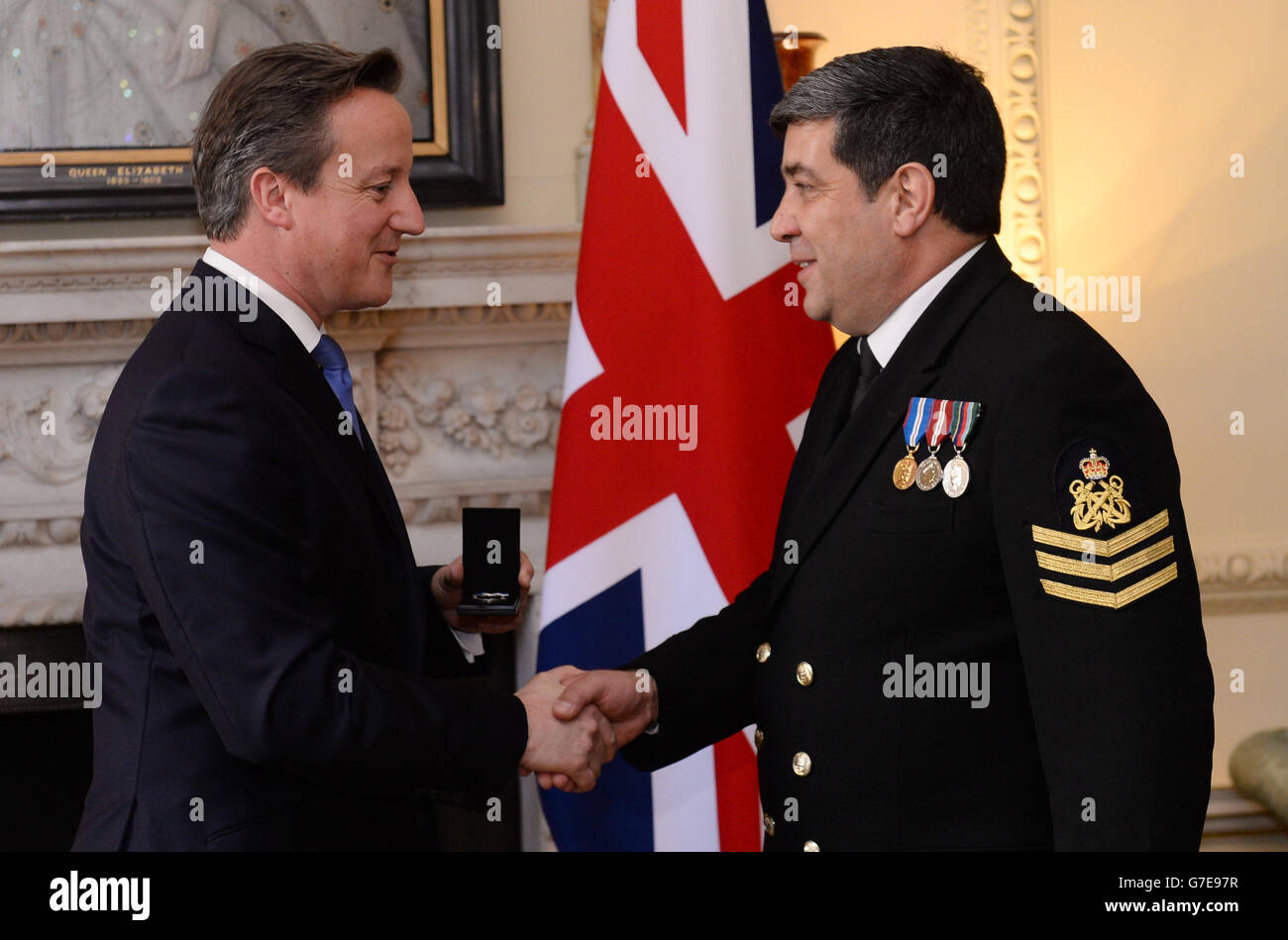Prime Minister David Cameron (left) presents Petty Officer Robert Cribb ...