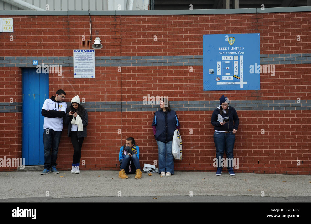 Fans wait outside the turnstiles at elland road hi-res stock ...