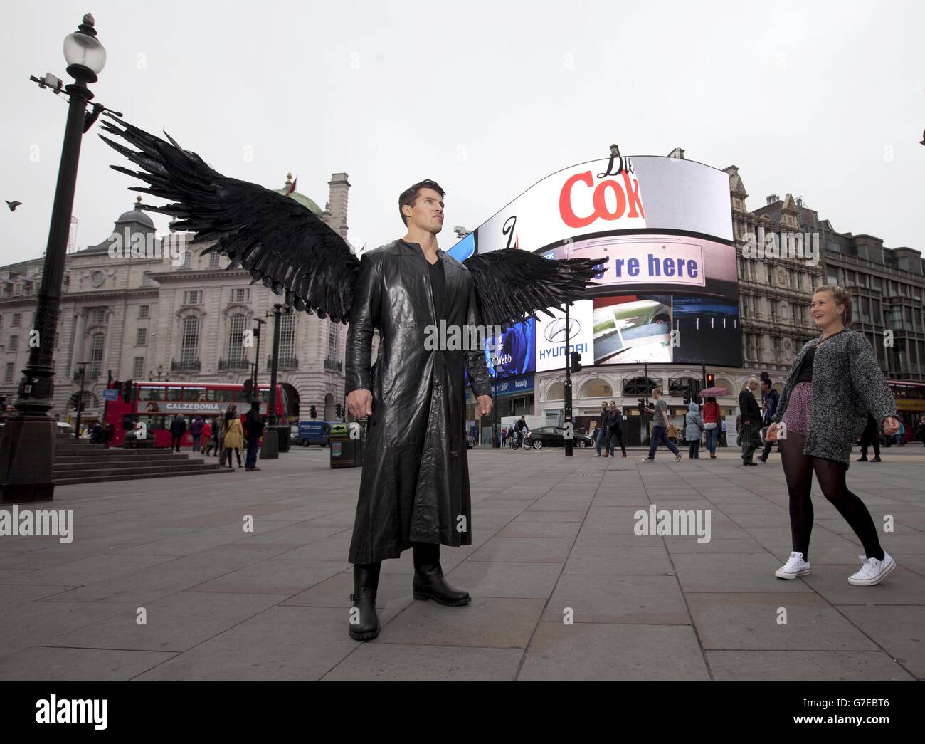 EDITORIAL USE ONLY An actor, dressed as an angel, at Piccadilly Circus ...
