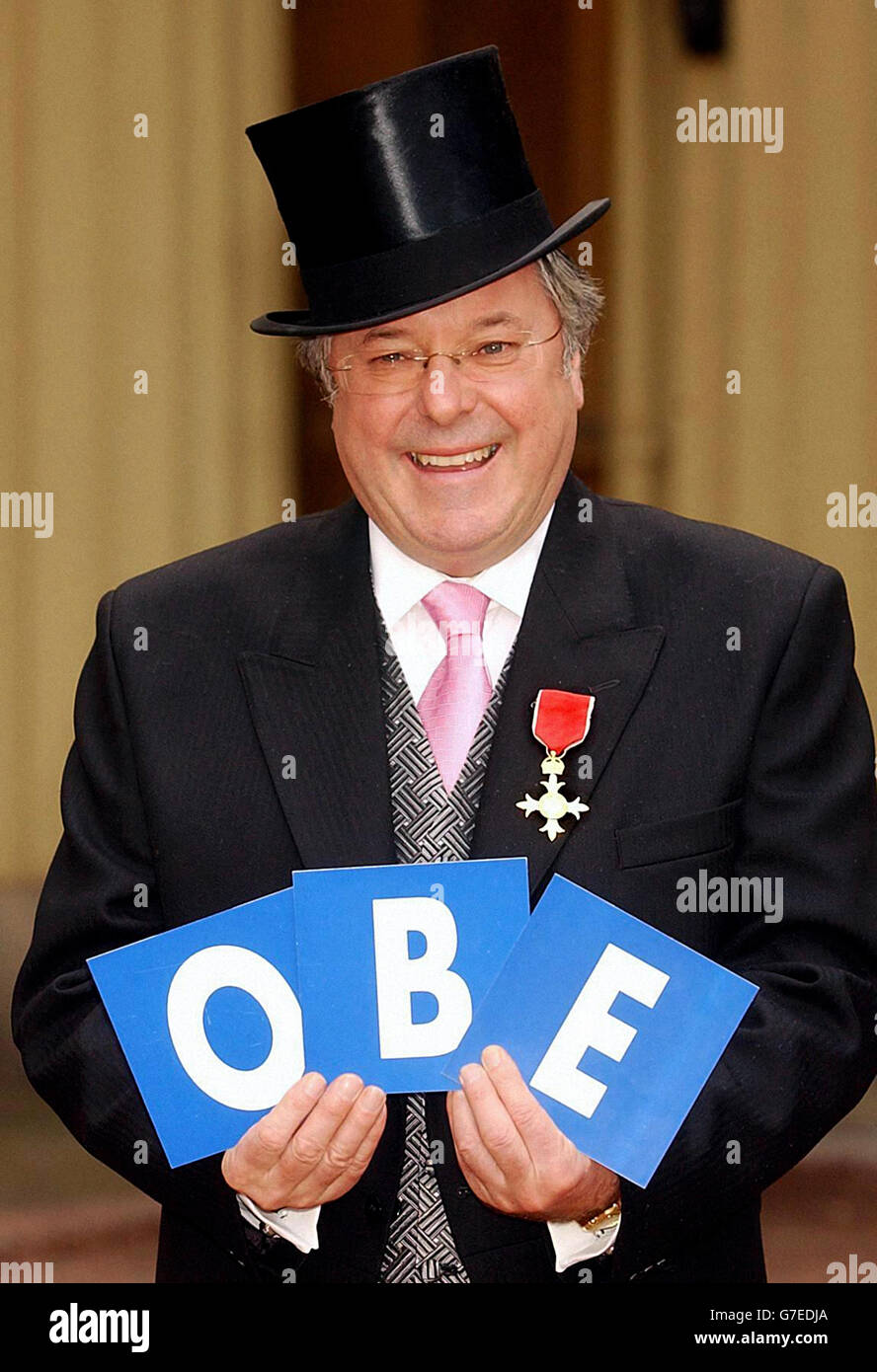 Countdown host Richard Whiteley, proudly wears and holds his OBE, after ...