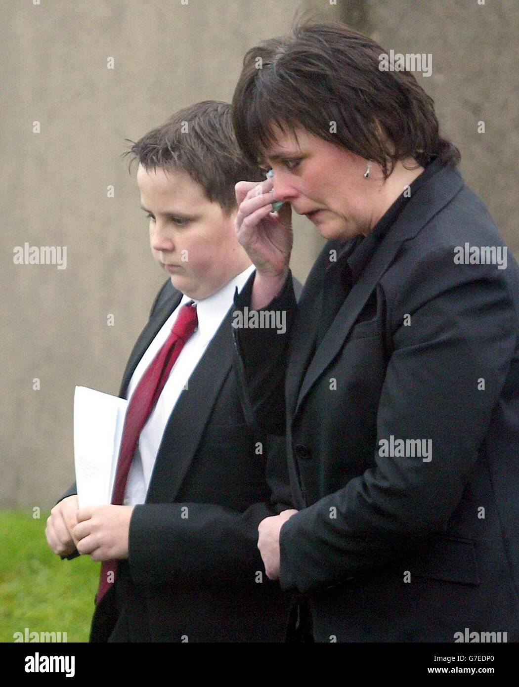 Ruth Winston Jones, with son Andrew, wipes a tear after the funeral of ...