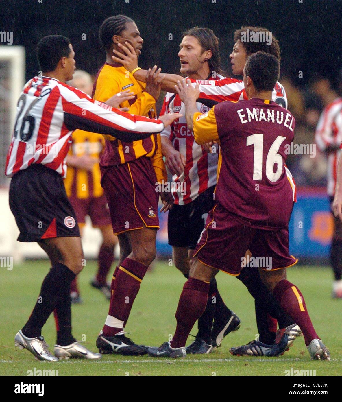 Deon Burton of Brentford (R) grabs the neck of Zema Abbey of Bradford ...