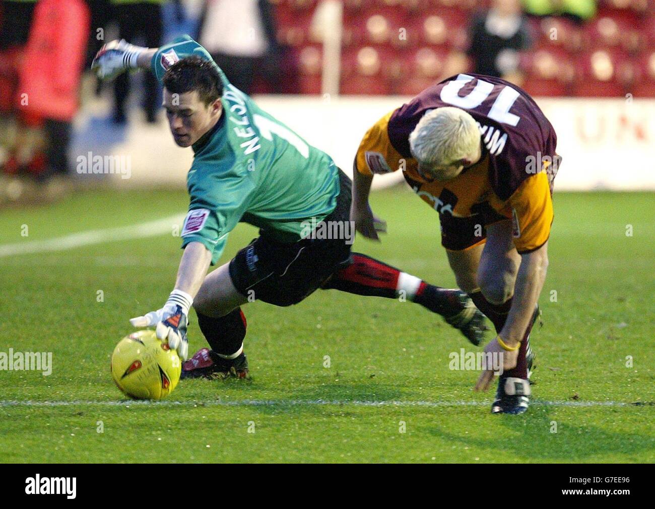 Brentford goalkeeper Stuart Nelson (left) gets his hand to the ball as ...