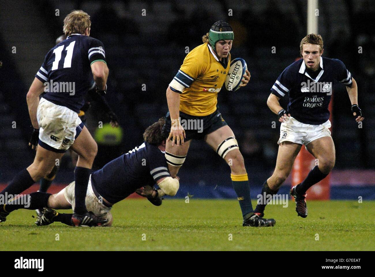 Australia's Stephen Hoiles breaks through the Scottish defence during ...