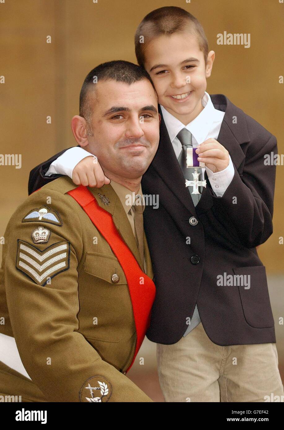 Sergeant Paul Kelly, with son Jack, nine, after collecting his Military ...