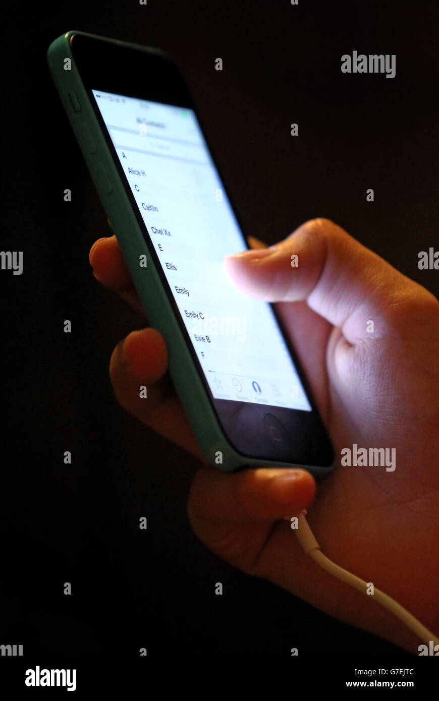 Stock picture of a teenage girl using an iphone mobile phone Stock ...