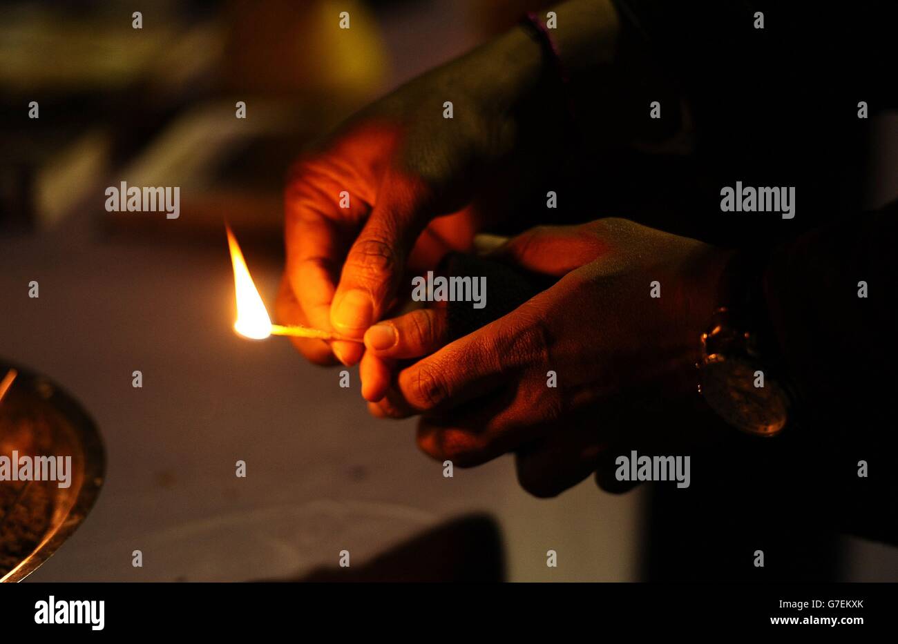 Devotees perform Aarti as they offer candles at the temple, as ...