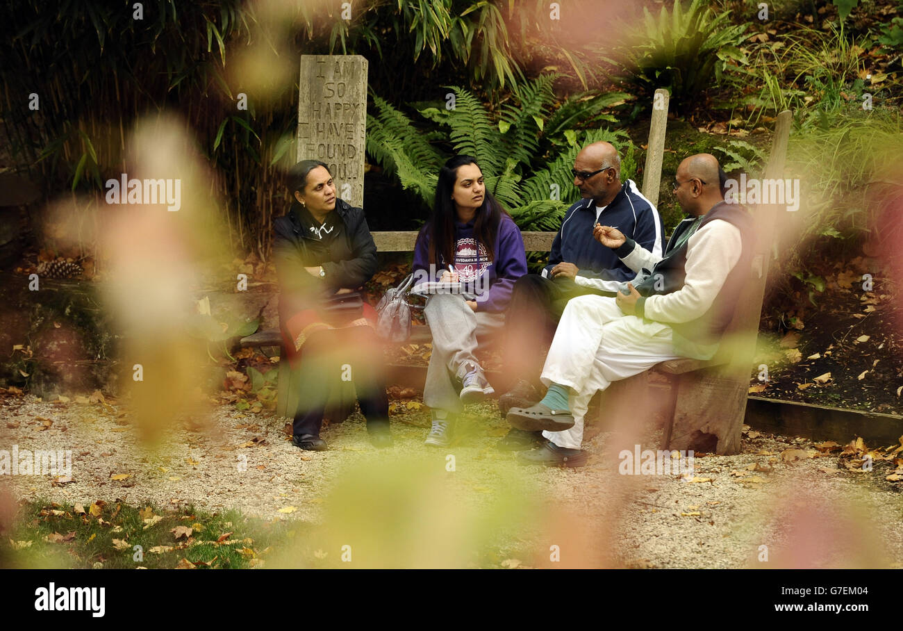 Devotees take a break in the George Harrison gardens, as thousands ...