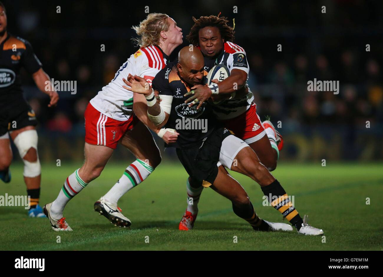 Wasps Tom Varndell is tackled by Harlequins Marland Yarde (right) and ...