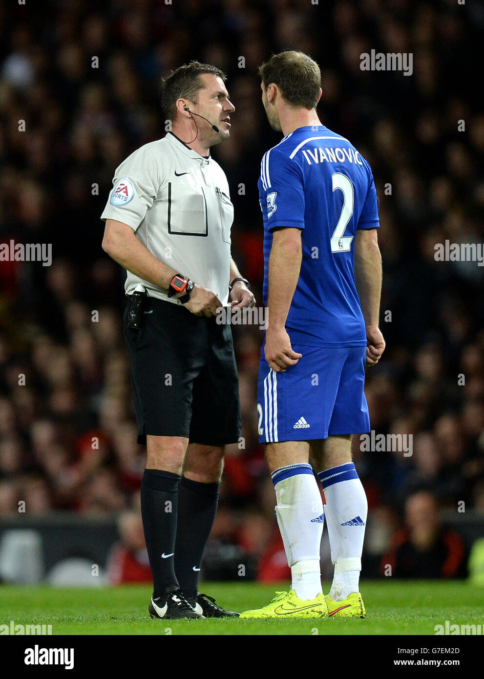 Referee Phil Dowd (left) has words with Chelsea's Branislav Ivanovic ...