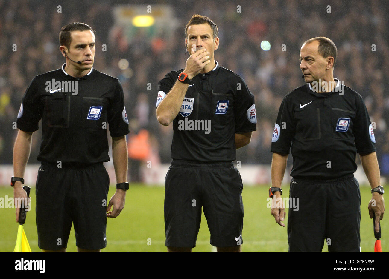 Referee Mark Clattenburg (centre) stands with the assistants before the ...
