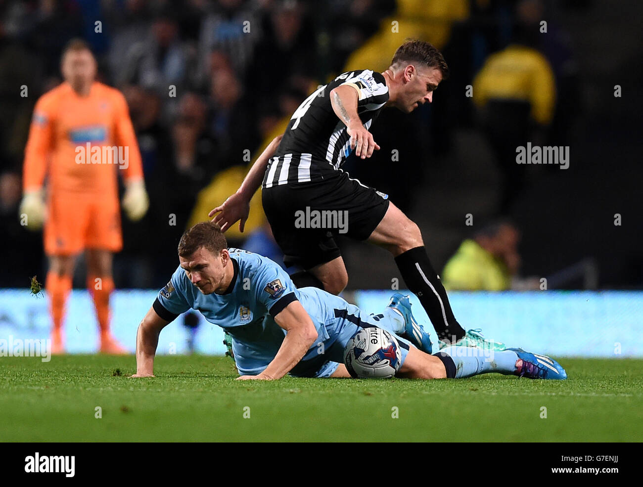 Manchester City's Edin Dzeko (floor) and Newcastle United's Ryan Taylor ...