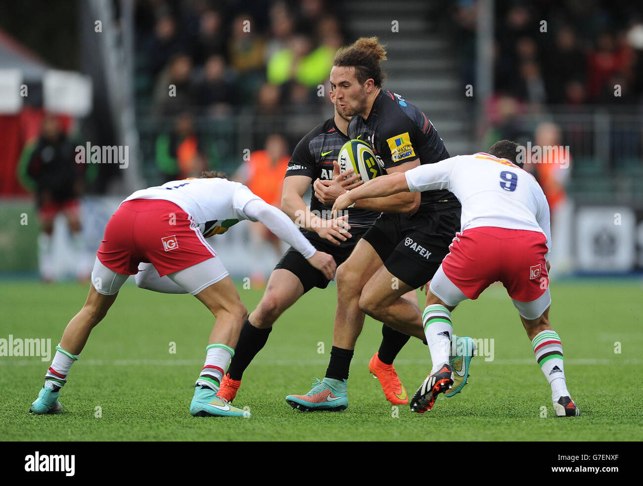 Saracens Mike Ellery is tackled by Harlequins Ollie Lindsay-Hall (left ...