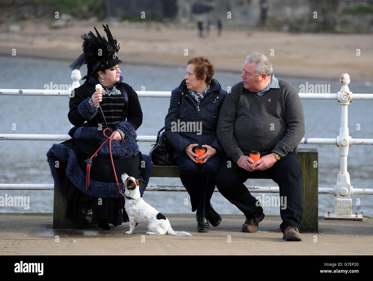 People sit along the promenade during the Whitby Goth Weekend, North ...
